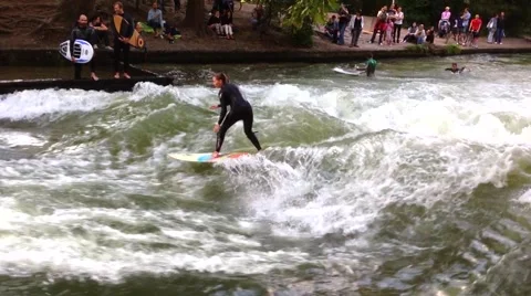 Surfers train on the Eisbach river in Mu... | Stock Video | Pond5