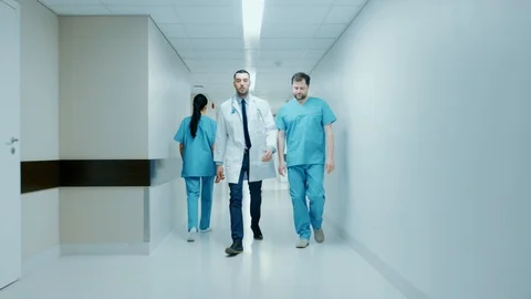 Surgeon and Doctor Walk Through Hospital... | Stock Video | Pond5