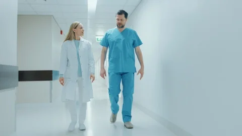 Surgeon and Female Doctor Walk Through... | Stock Video | Pond5