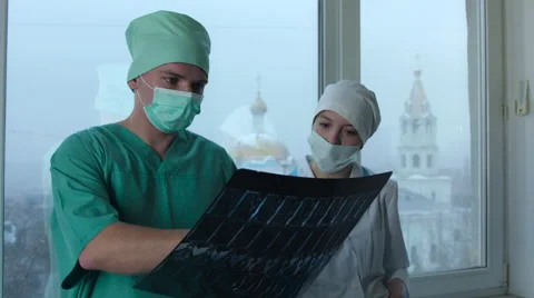Surgeon and Nurse Arguing the X-Ray Pict... | Stock Video | Pond5