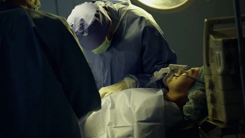 Surgeon doing surgery inside operating r... | Stock Video | Pond5