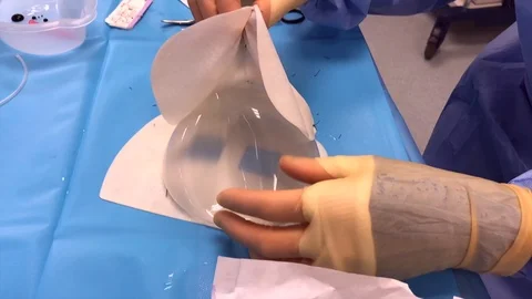 A surgeon finalises sutures on a prosthe... | Stock Video | Pond5