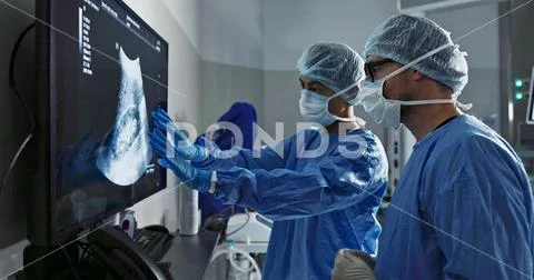 Surgery, x ray and a team of doctors in the hospital for an operation ...