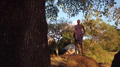 Suri tribe man standing on a giant rock ... | Stock Video | Pond5