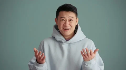 Surprised Asian man clapping hands | Stock Video | Pond5
