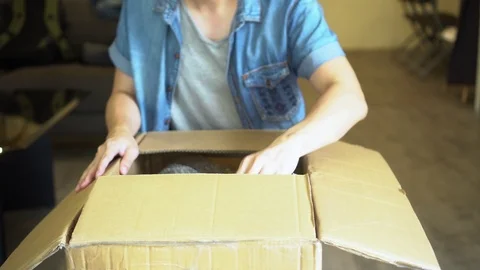 Surprised Asian man unboxing package at ... | Stock Video | Pond5