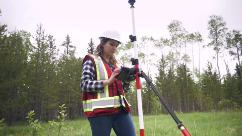 Surveyor using equipment to measure fiel... | Stock Video | Pond5