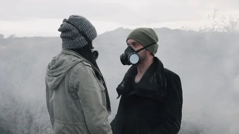 A survivor lovely couple in gas mask hug... | Stock Video | Pond5