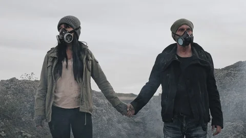 A survivor lovely couple in gas mask goi... | Stock Video | Pond5