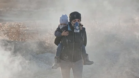 A survivor mother carring her son in gas... | Stock Video | Pond5