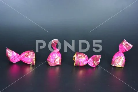 Sweet and tasty candies with cognac and cherry in purple packaging ...