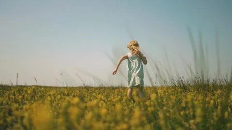 Sweet blond little girl running in bloom... | Stock Video | Pond5