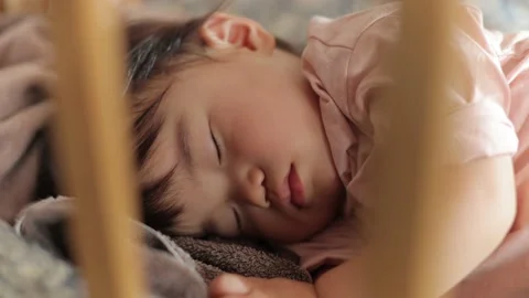 Sweet nap of asian baby girl on brown to... | Stock Video | Pond5