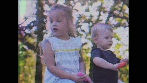 Sweet Siblings Sitting Together Outdoors | Stock Video | Pond5