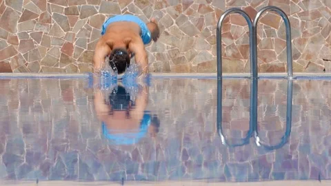 Swimmer jumps into the pool and doing th... | Stock Video | Pond5