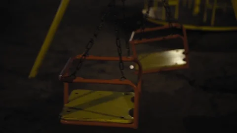 Swing on the playground at night, no one... | Stock Video | Pond5
