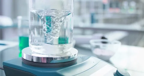 Swirling vortex of water in beaker with ... | Stock Video | Pond5