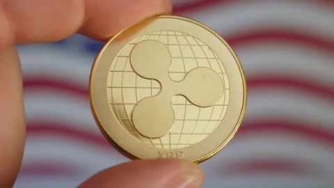 Symbolic 'Ripple' XRP Coin in Hand Again... | Stock Video | Pond5