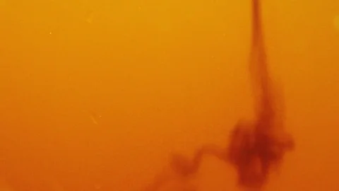 Syrup pouring into water with yellow bac... | Stock Video | Pond5