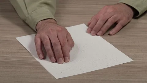 At a Table a Blind Men Is Reading a Brai... | Stock Video | Pond5