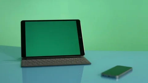Tablet with green screen on a green bac... | Stock Video | Pond5