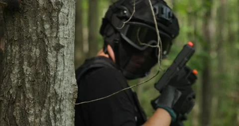 Tactical army guy looks down and pull ou... | Stock Video | Pond5