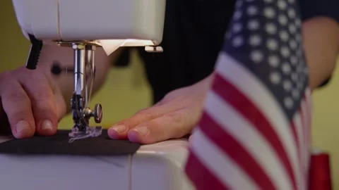 Tailor Sewing Next To An American Flag | Stock Video | Pond5
