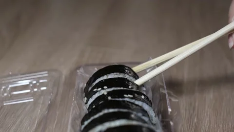 Taking Korean Kimbap out of plastic pack... | Stock Video | Pond5