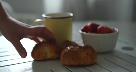taking pastry off the table with morning... | Stock Video | Pond5