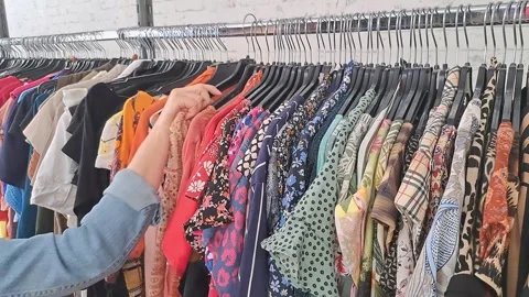 Taking a piece of clothing off the rack ... | Stock Video | Pond5