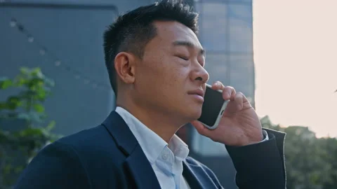 Talking calling speaking with phone Asia... | Stock Video | Pond5
