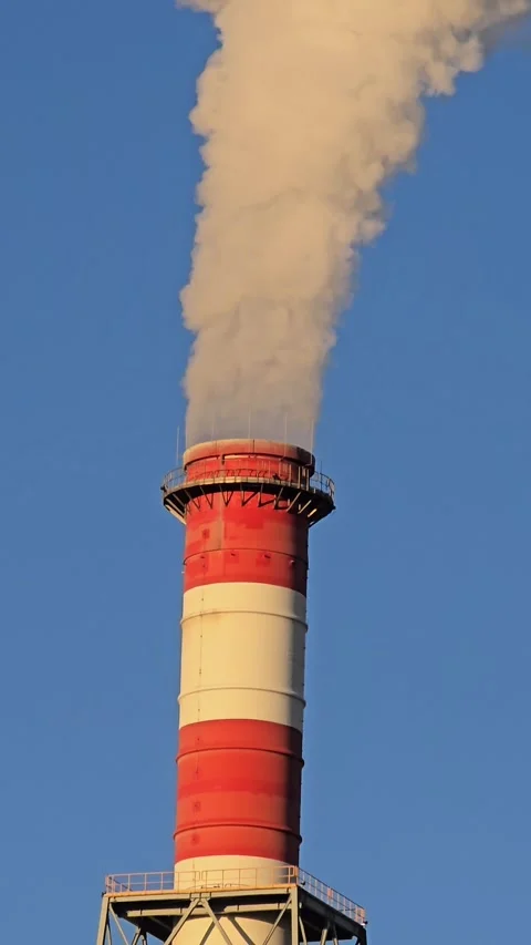 A tall chimney emitting a plume of smoke... | Stock Video | Pond5
