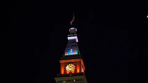 Tall clock tower lit with rainbow colore... | Stock Video | Pond5