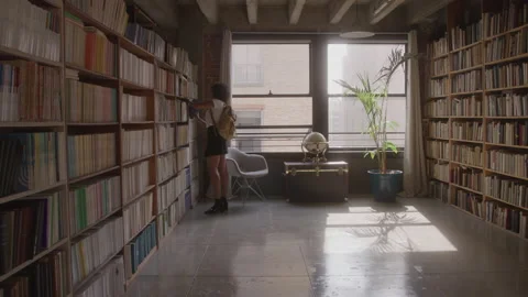 Tall Female Browses Library Shelves Duri... | Stock Video | Pond5