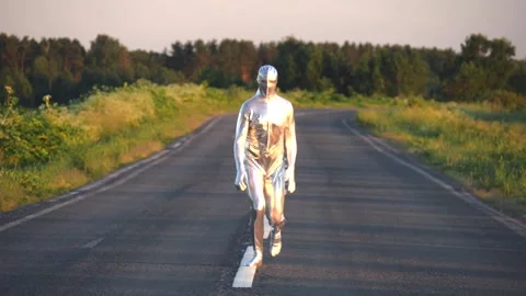 Tall slender man in silver suit is fully... | Stock Video | Pond5