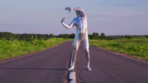 Tall slender man in silver suit is fully... | Stock Video | Pond5