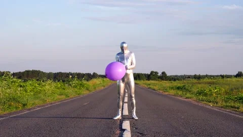 Tall slender man in silver suit is fully... | Stock Video | Pond5