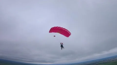 tandem parachute is landing, cloudy weat... | Stock Video | Pond5