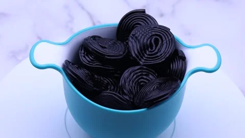 Tasty black licorice candies on white ma... | Stock Video | Pond5