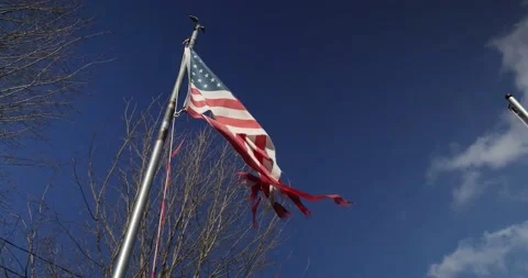 Tattered American flag waving in the win... | Stock Video | Pond5