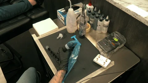 Tattoo machine dip in ink work shop stat... | Stock Video | Pond5