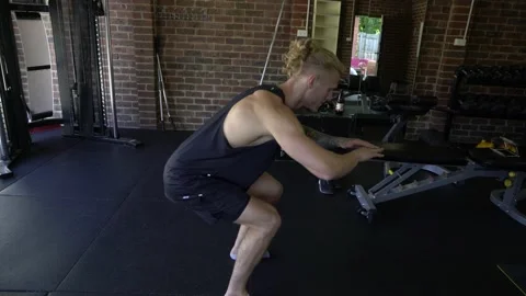 Tattoo man muscles in home gym squat to ... | Stock Video | Pond5