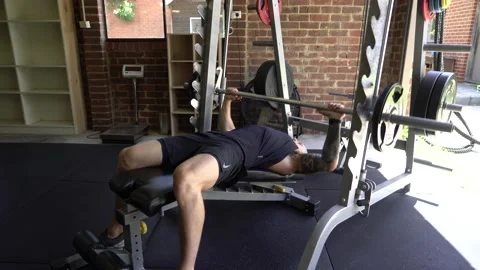 Tattooed man in home gym smith machine b... | Stock Video | Pond5
