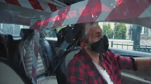 Taxi driver in face mask picking up blac... | Stock Video | Pond5