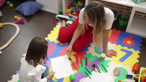 Teacher with boy and girl sitting on flo... | Stock Video | Pond5