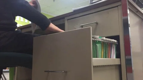 Teacher filing student papers in filing ... | Stock Video | Pond5