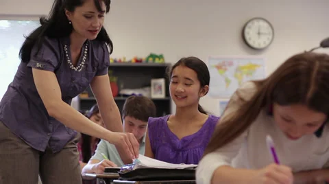 Teacher helping junior high student in c... | Stock Video | Pond5