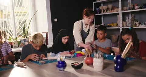 Teacher shows student technique of model... | Stock Video | Pond5