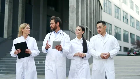Team of doctors walk outside modern hosp... | Stock Video | Pond5