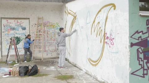 Team of graffiti artists spraying graffi... | Stock Video | Pond5